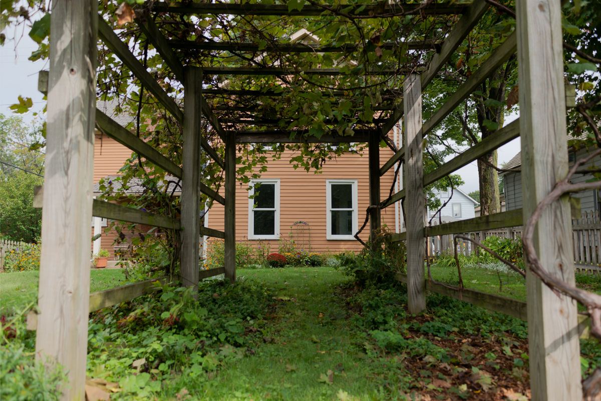 Burchfield Homestead rear view through the Grape Arbor. Courtesy of The ...